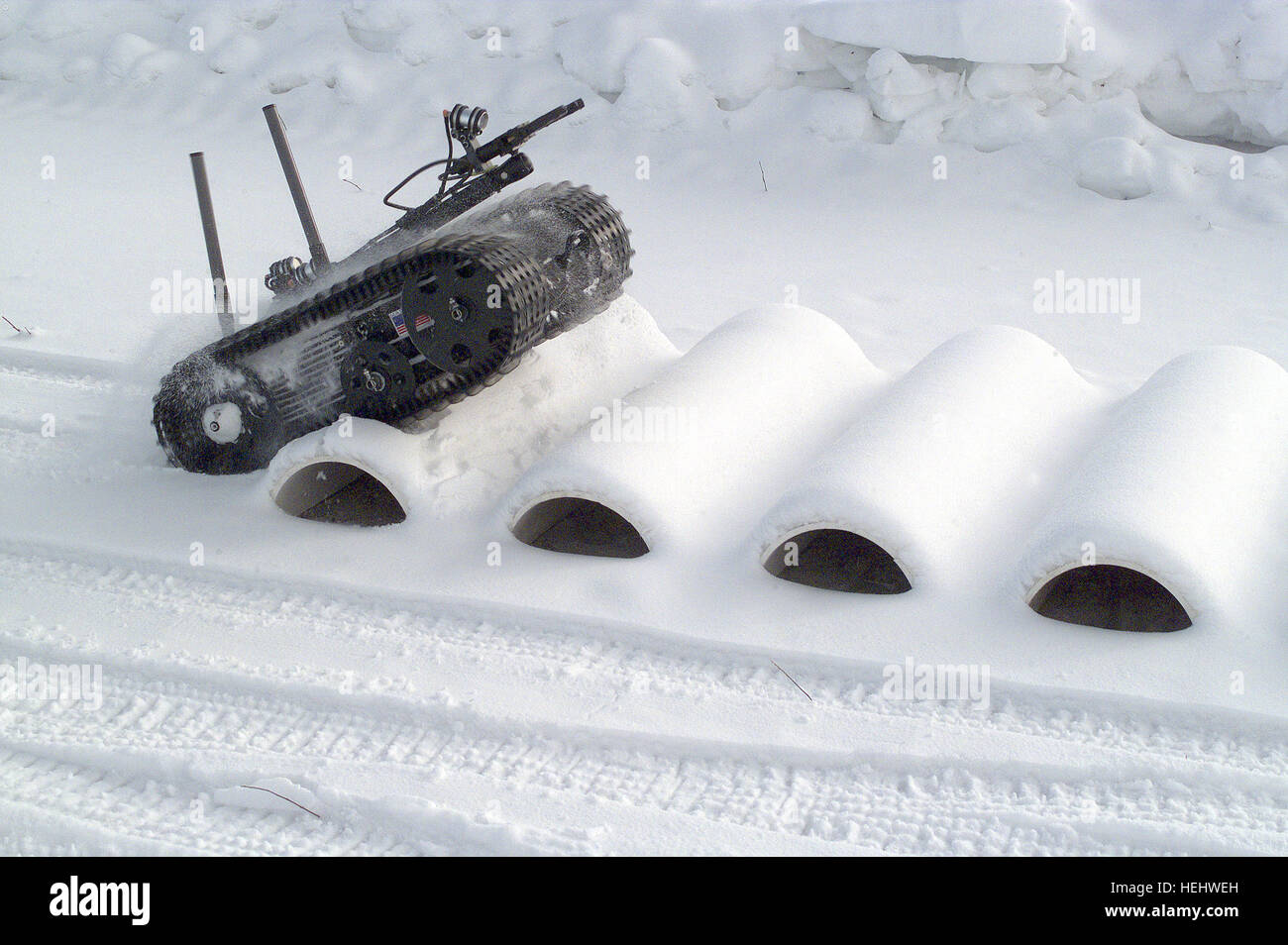 A robotic vehicle undergoes mobility testing on a bump course at the ...