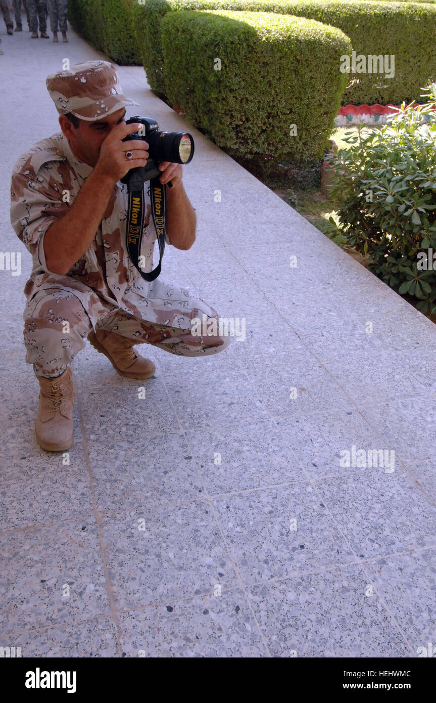 An Iraqi soldier kneels to capture a photo during a fundamentals of ...