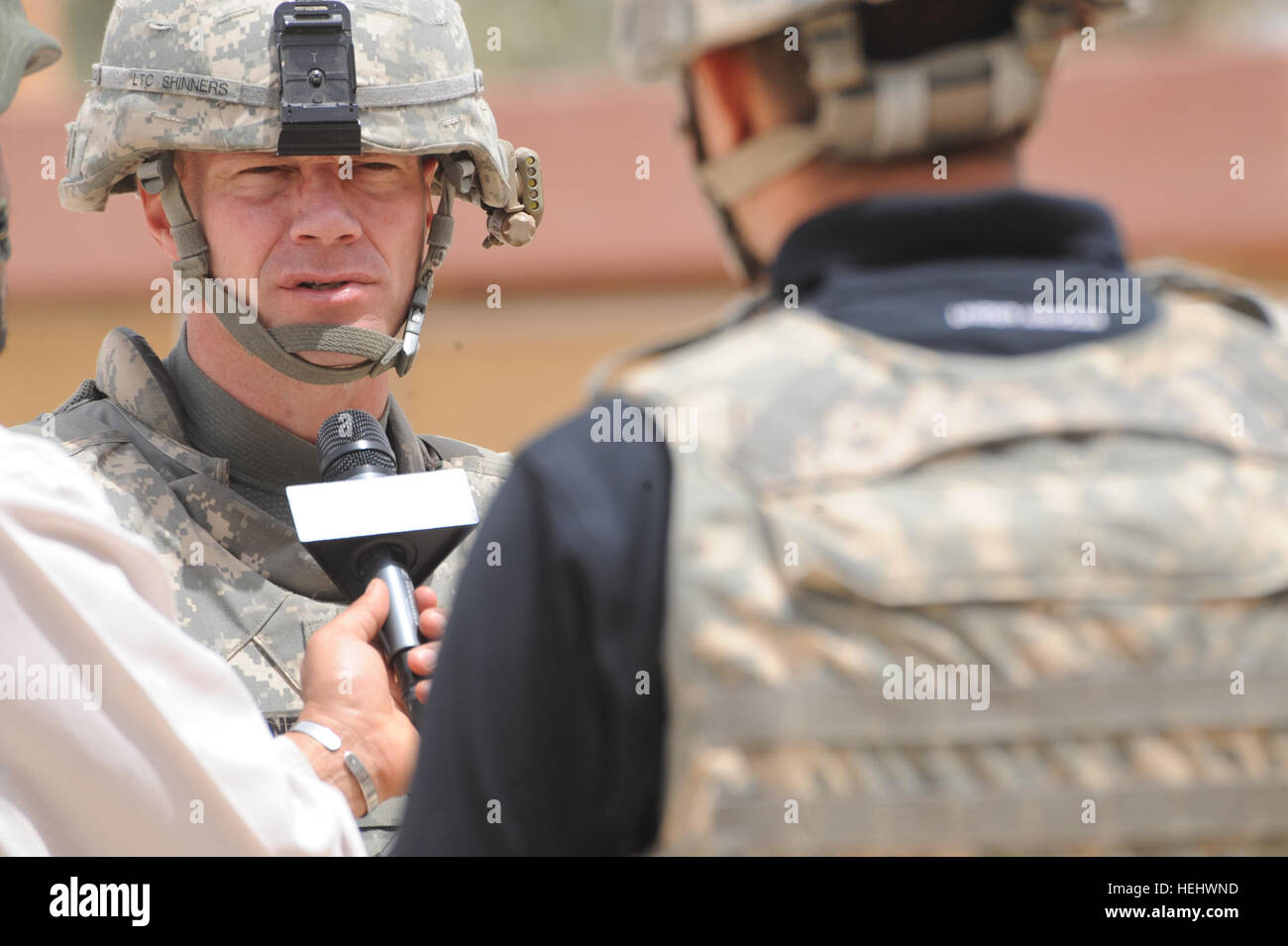 An Iraqi television reporter with the help of an interpreter interviews ...