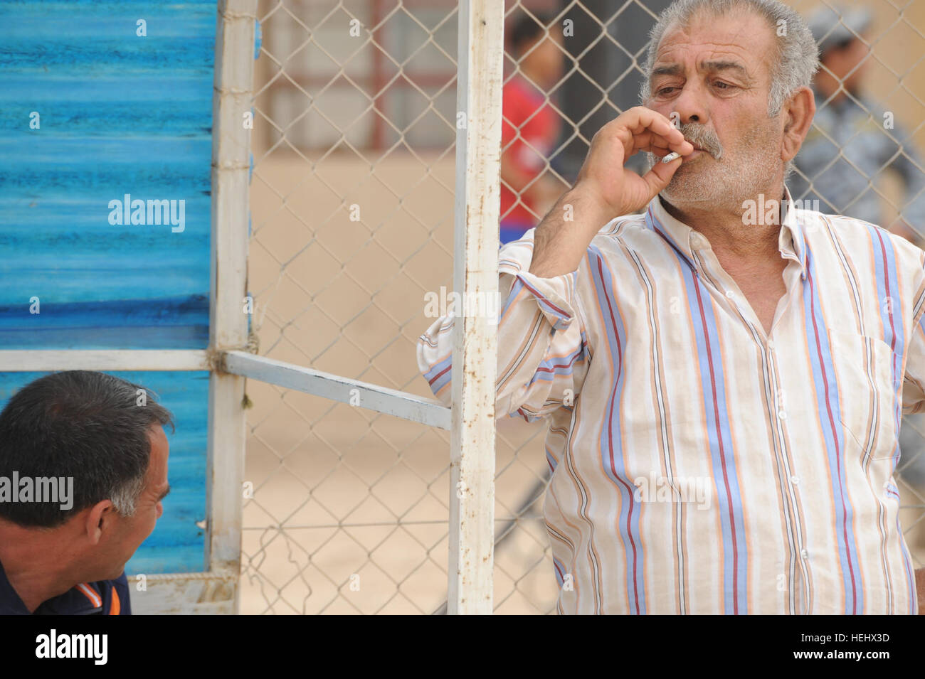 A local Iraqi man watches a public soccer games in Karadah, eastern ...