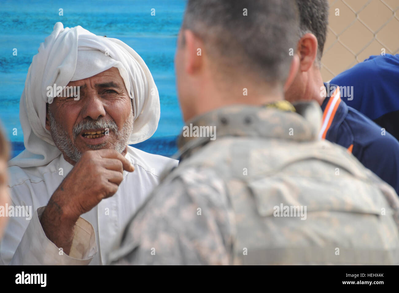 An Iraqi man talks with U.S. Soldiers of 3rd Brigade Combat Team, 82nd ...