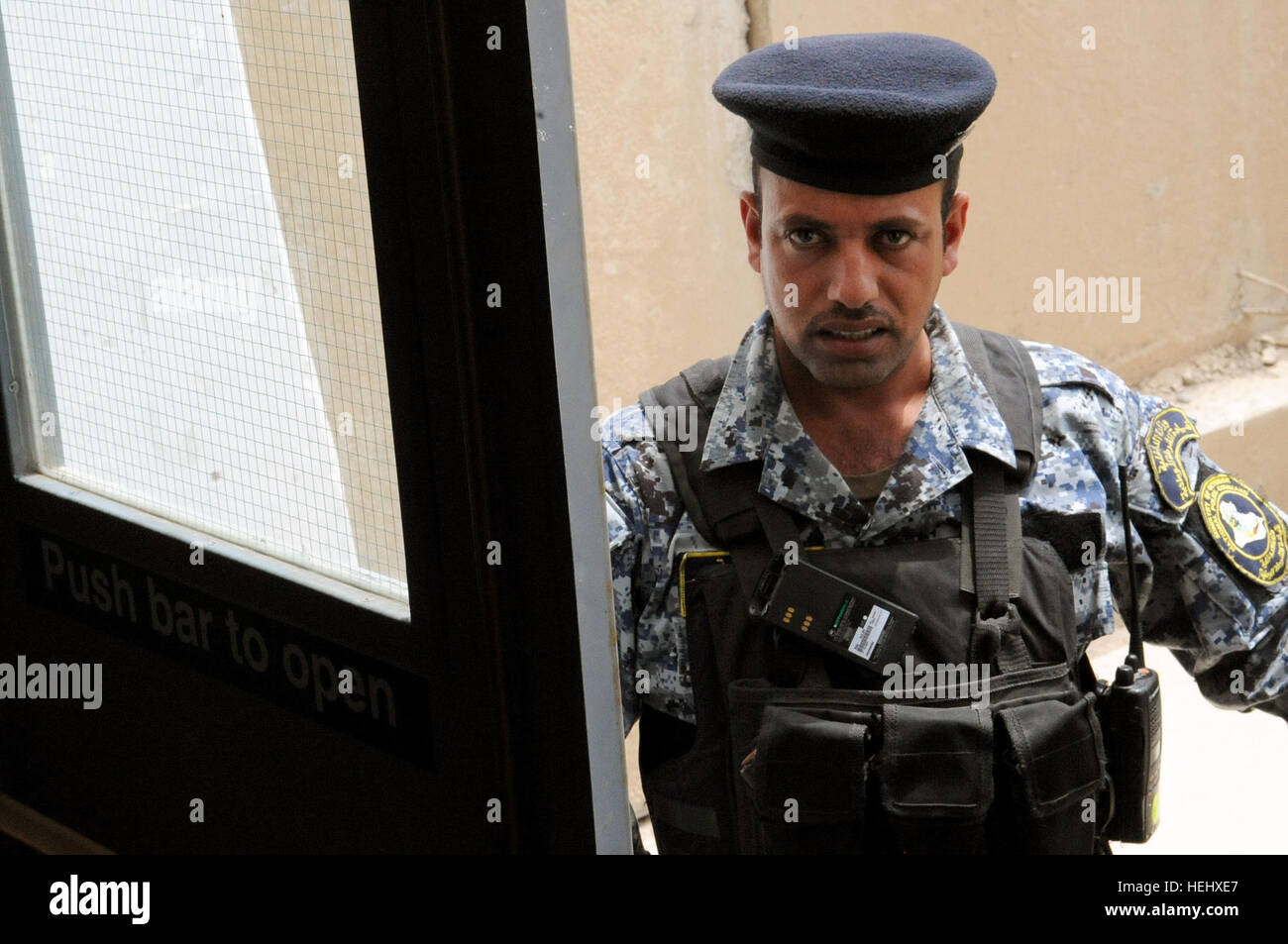 An Iraqi national policeman helps provide security during a meeting ...