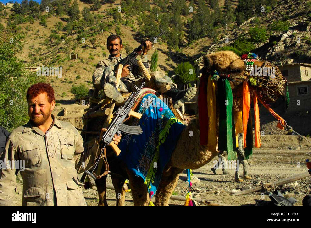 Afghan border police patrol men enjoy riding on a camel in East Patika ...