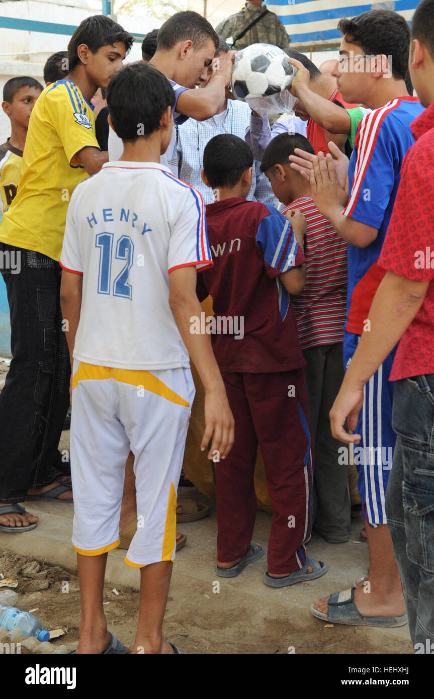 Iraqi children receive soccer balls during a humanitarian mission May ...