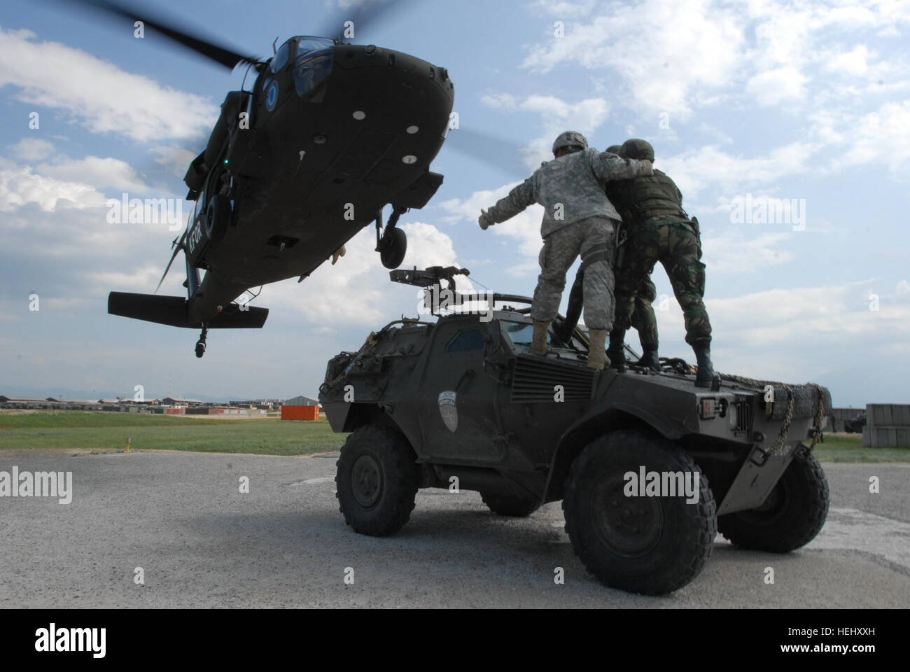 Sgt. Brian Lyman Of US Army watches closely as Portuguese soldiers hook ...
