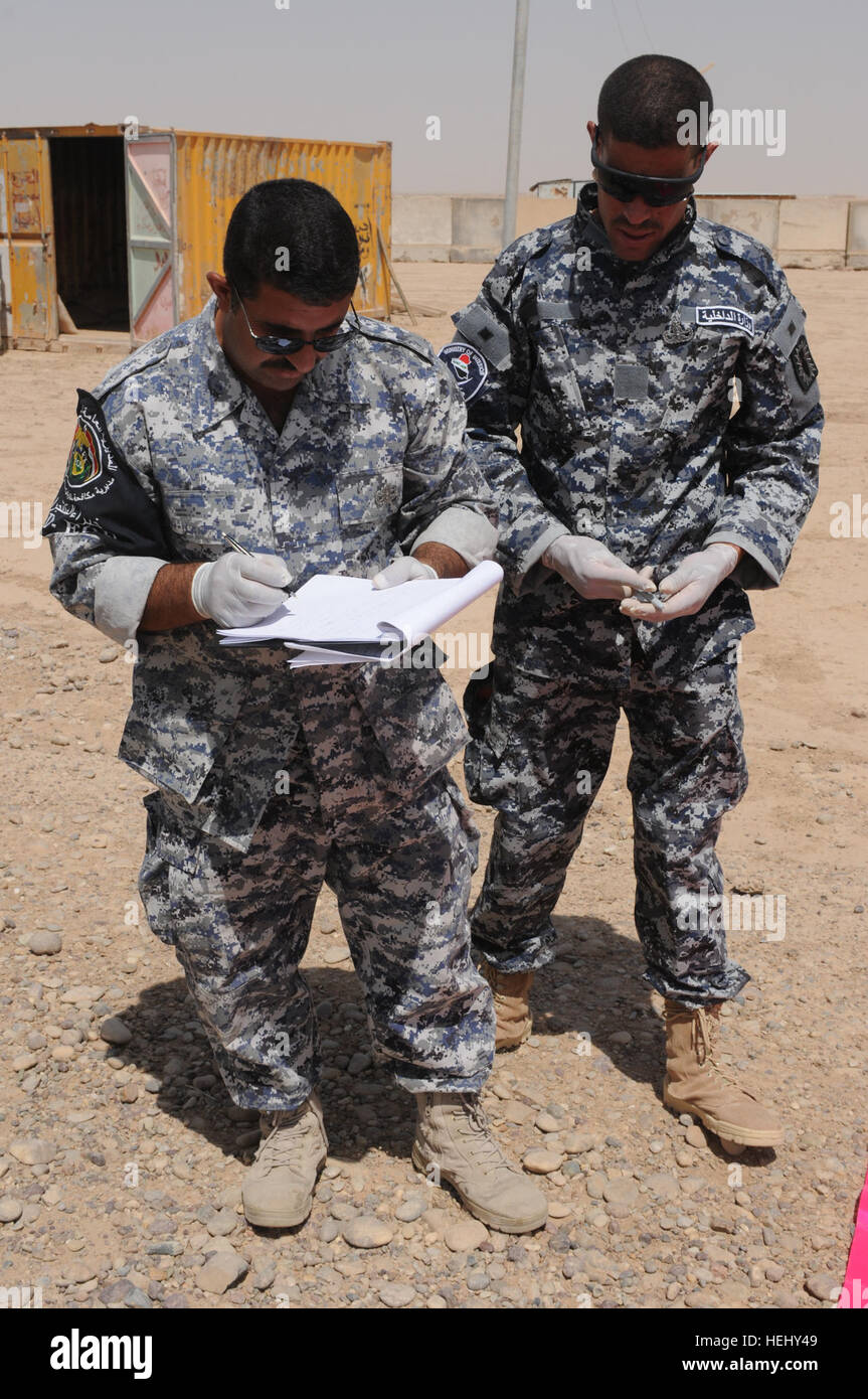 Iraqi policeman from Counter Explosive Team writes down information ...