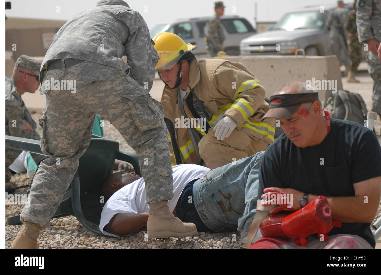 Soldiers give medical attention to the wounded during a mass casualty ...