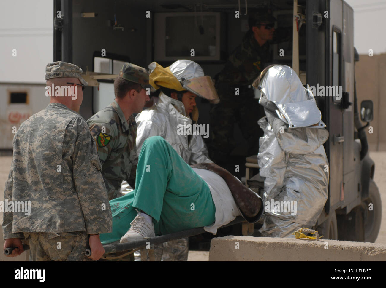 Soldiers life a casualty into an ambulance during a mass casualty ...