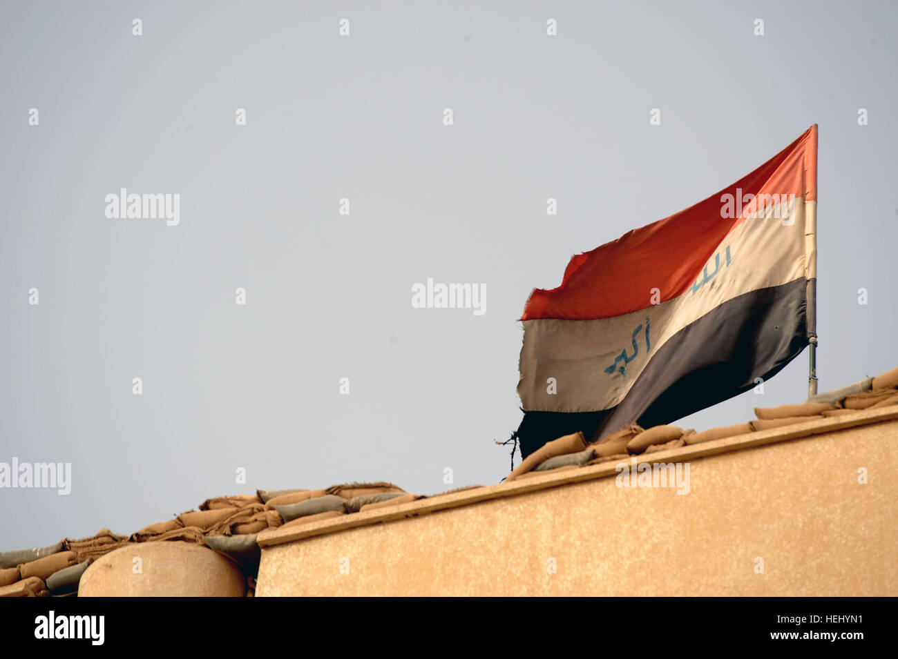 The Iraqi flag flies from the roof of Joint Security Station Oubaidy in ...