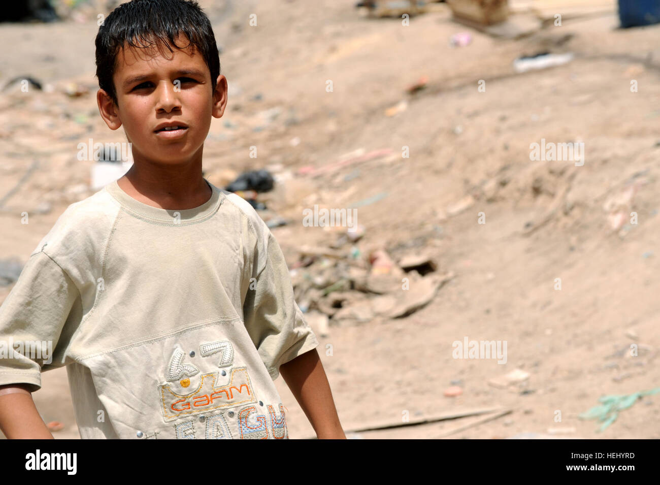 An Iraqi boy looks at the camera on a market street in eastern Baghdad ...