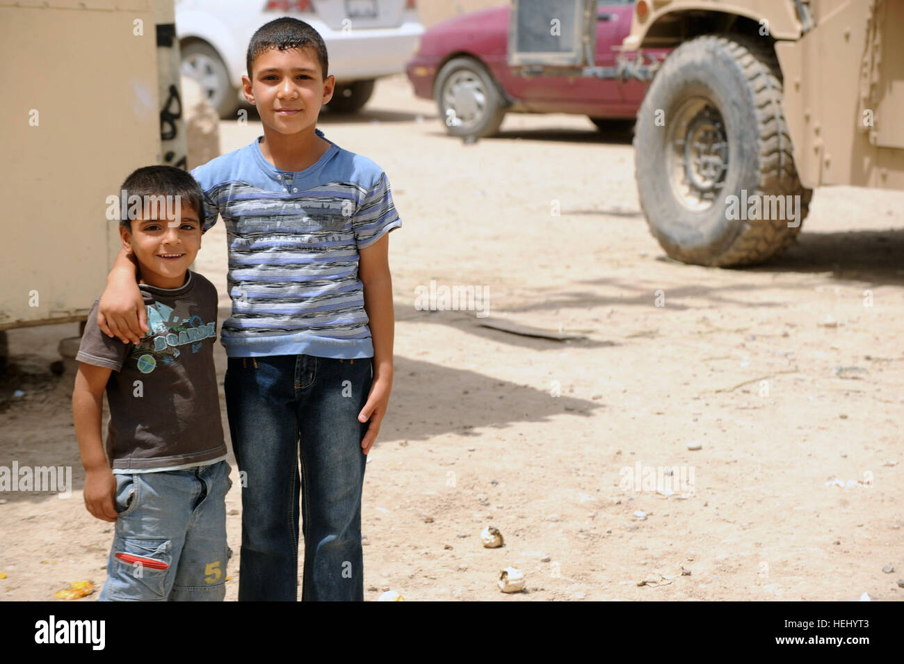 Iraqi boys smile for the camera on a market street in eastern Baghdad ...