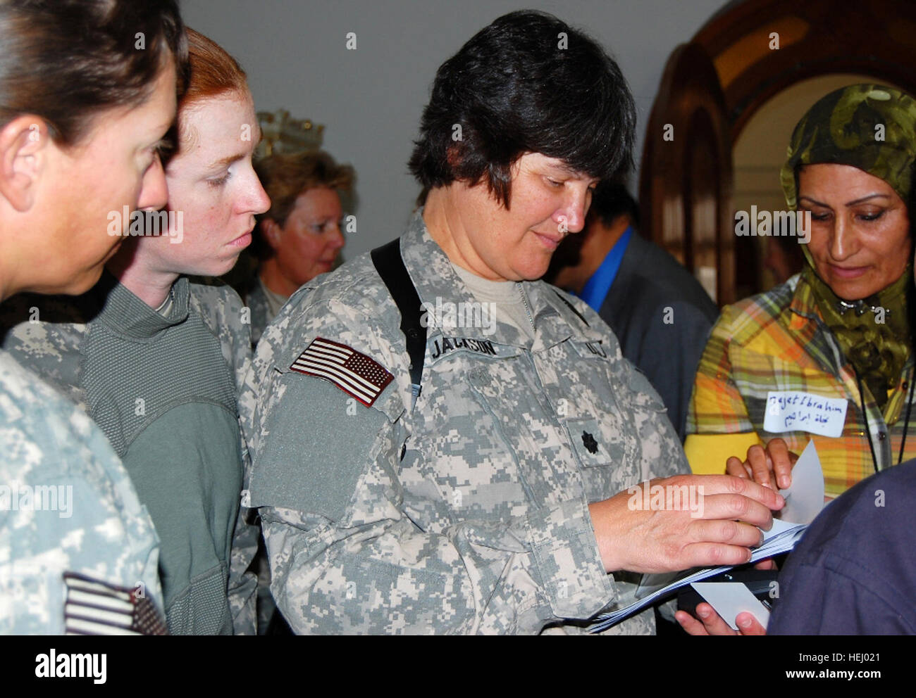 An Iraqi woman proudly shows Lt. Col. Kelly Jackson, center ...