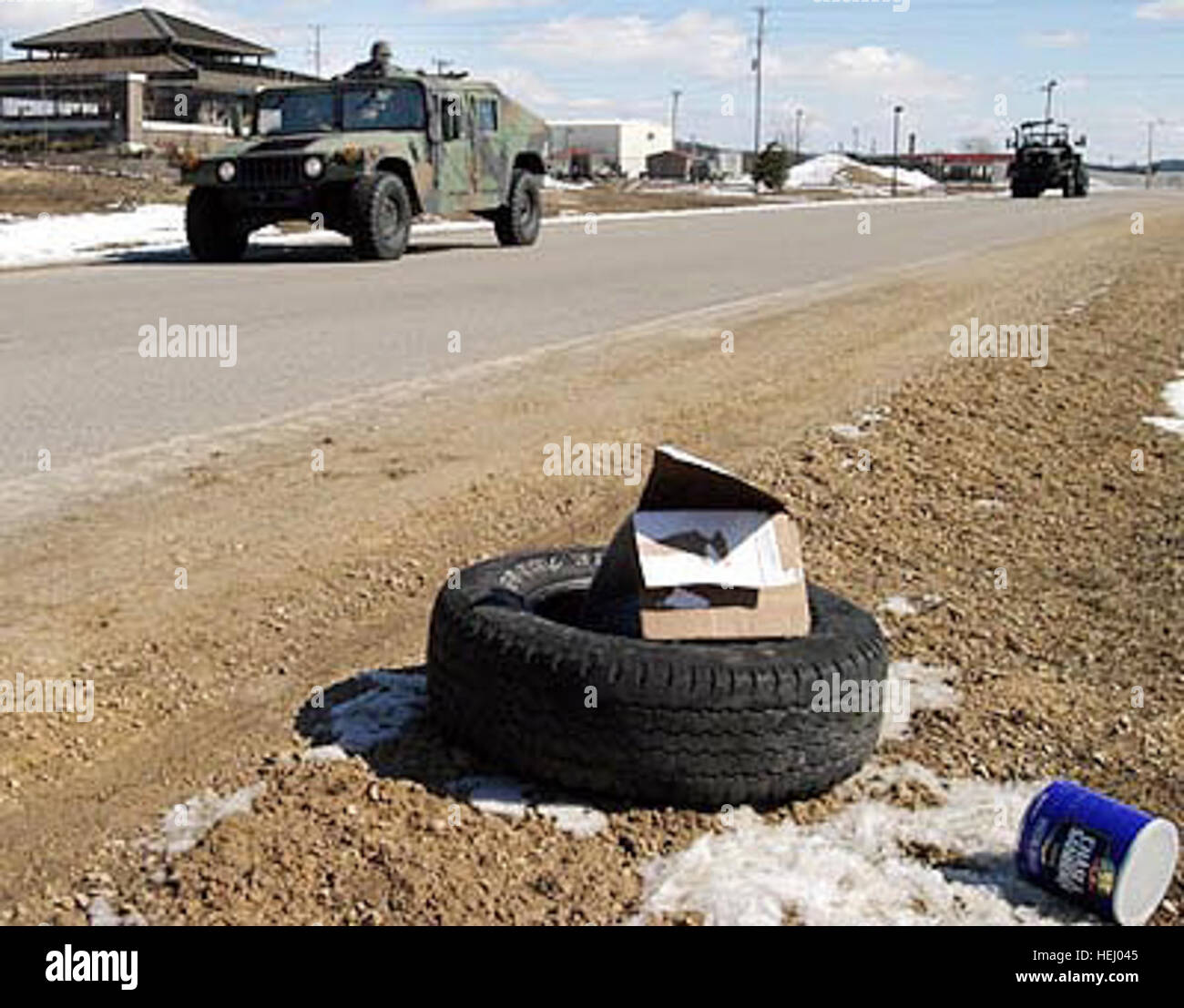 Students operate a HMMWV vehicle past a simulated IED during a counter ...