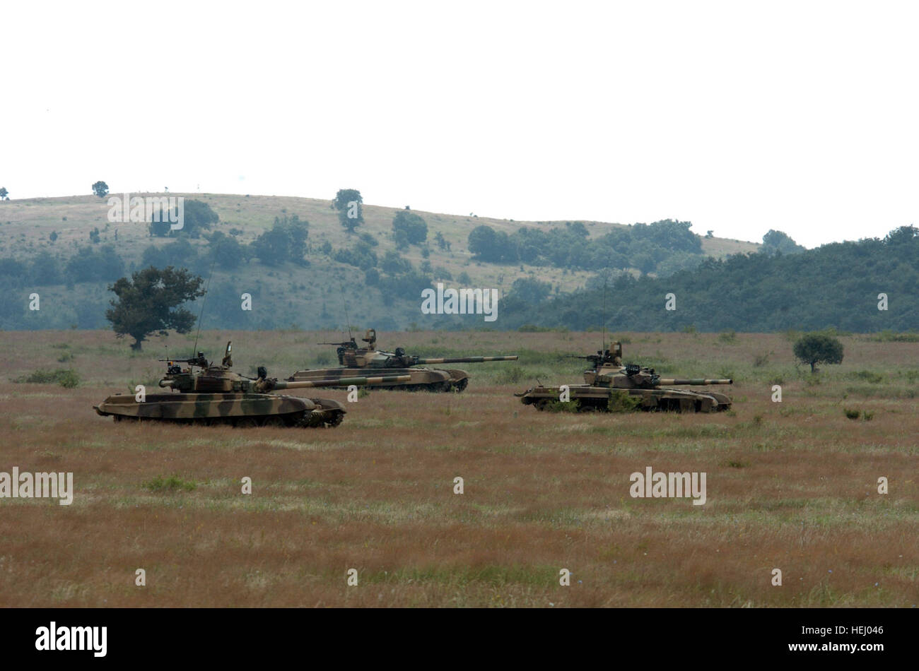 Three T-72 Main Battle Tanks move forward to attack the OPFOR during a ...