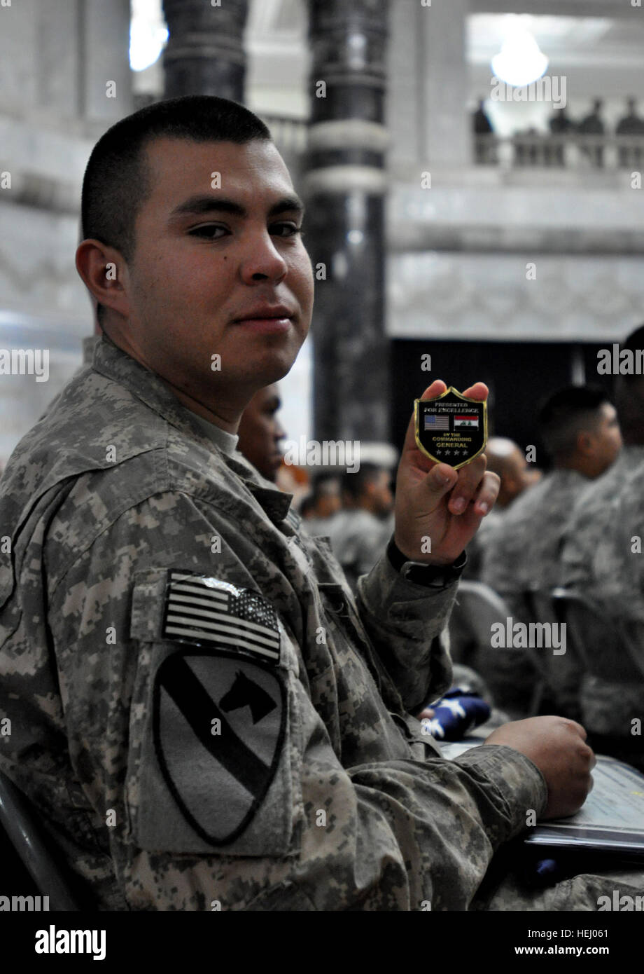 Army Pfc. Aldo Flores holds up the coin Multi National Force - Iraq ...