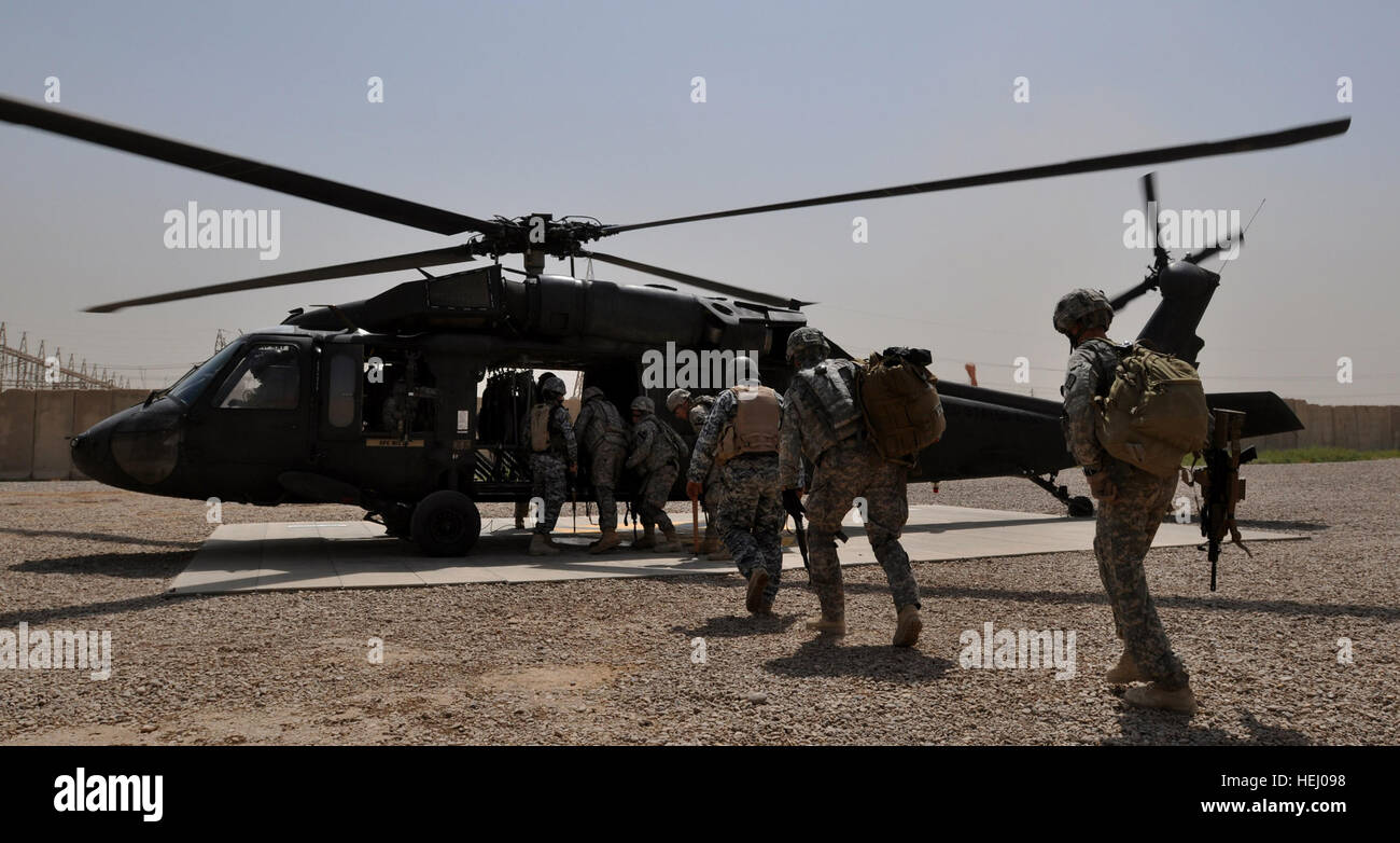 Iraqi national police and U.S. Soldiers mount a UH-60 Black Hawk on a ...