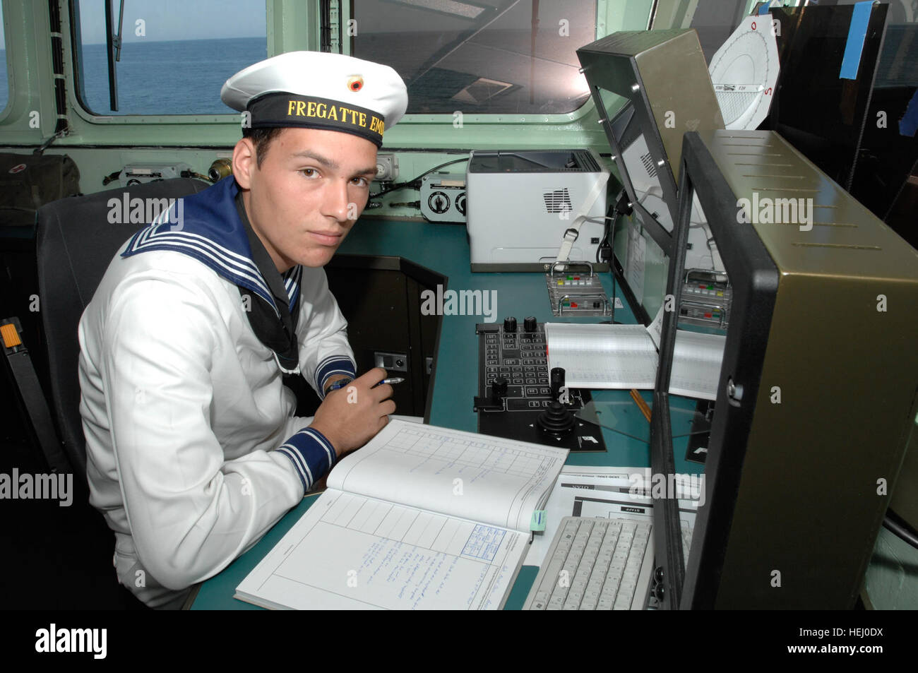 Crew members of the German frigate Emden operate their stations while ...
