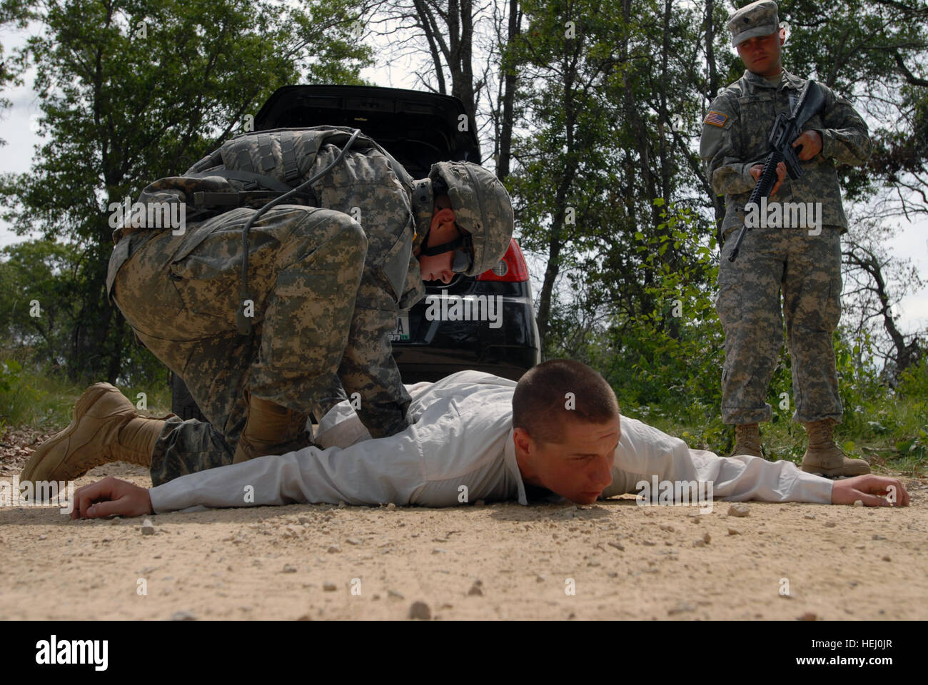 A specialist from the 200th Military Police Command searches a ...
