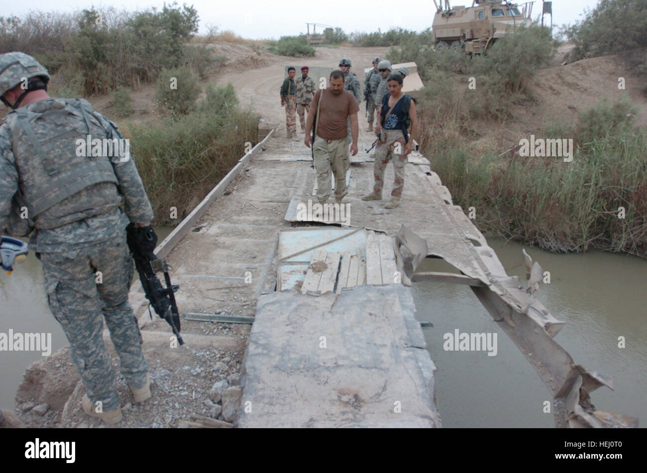 Iraqi soldiers look at a destroyed bridge near the village of Shubaykah ...