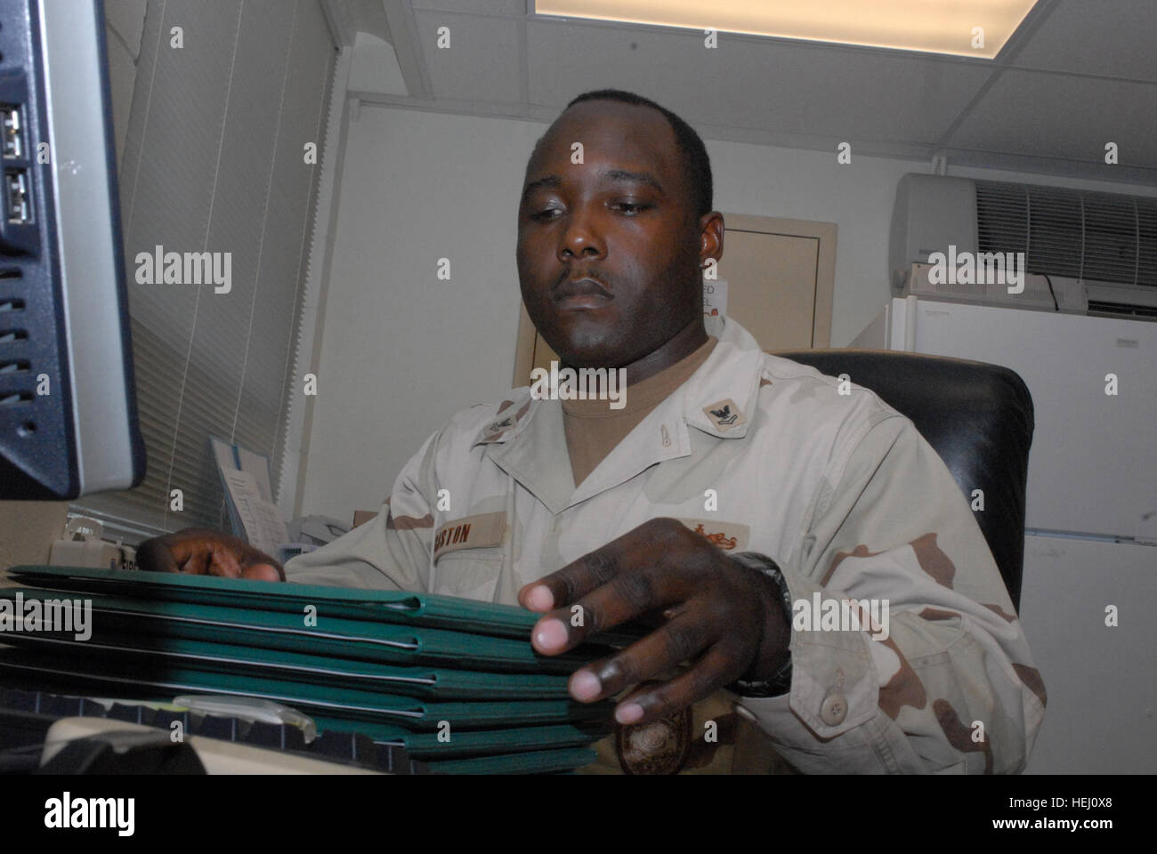 A Navy Petty Officer prepares and processes award certificates and ...
