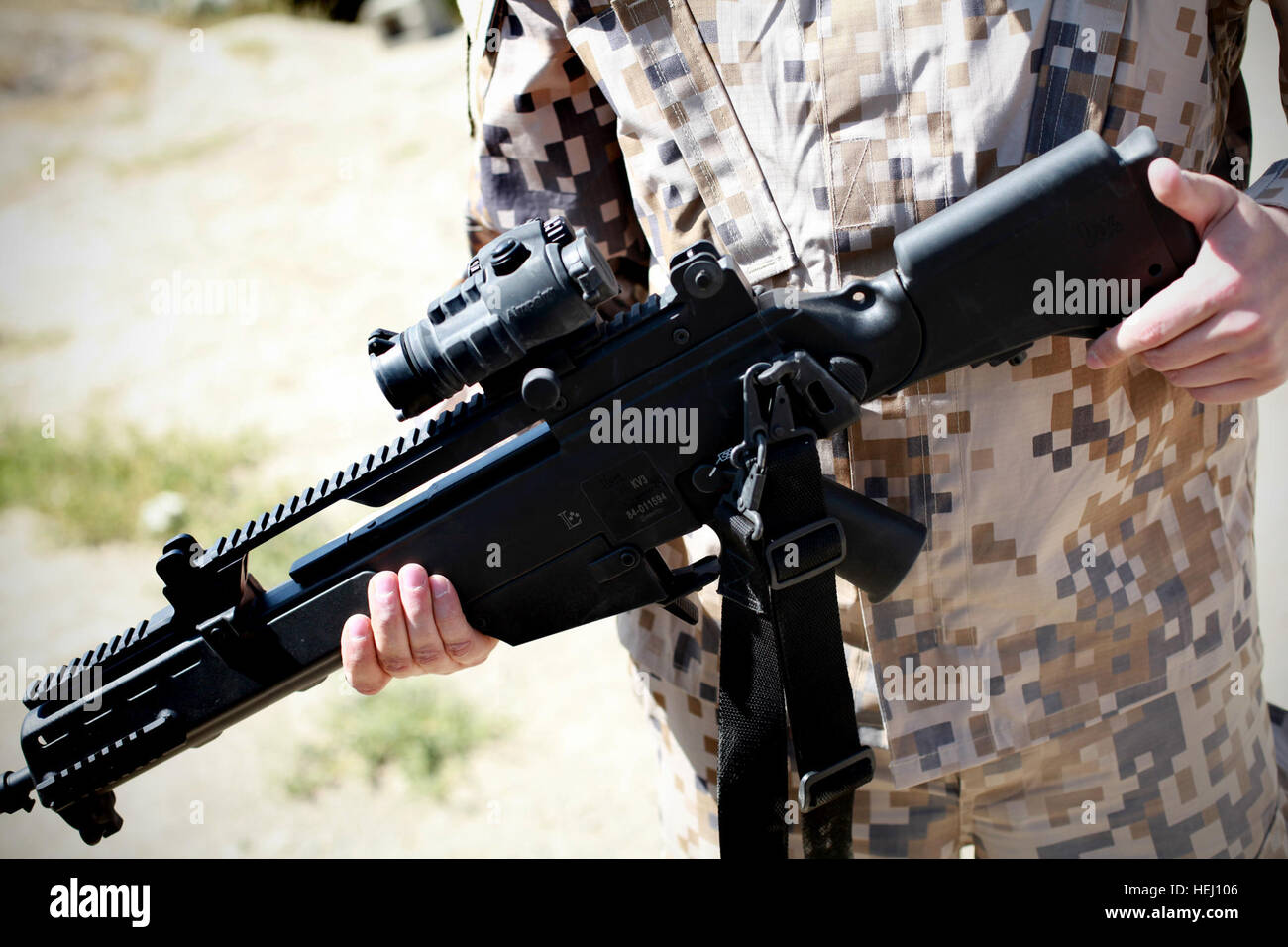 A Coalition Soldier, from Latvija, demonstrates the Heckler and Koch ...
