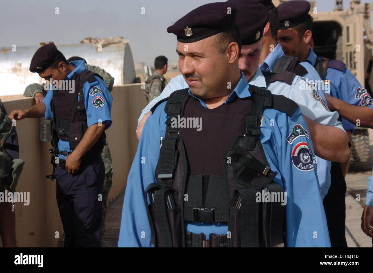 Iraqi police officers of the Yaychi police station wait for their cue ...