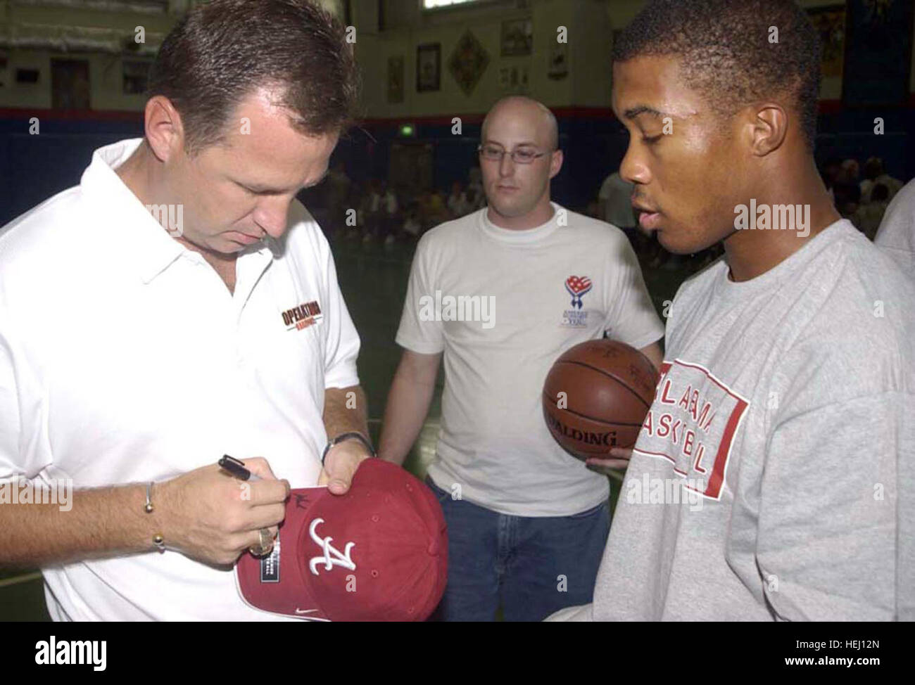 Mark Gottfried, University of Alabama head coach, signs an Alabama hat ...