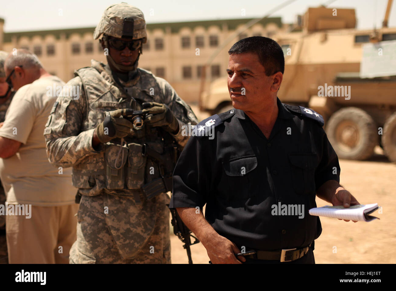 An Iraqi police officer calls off names from a list during a ...