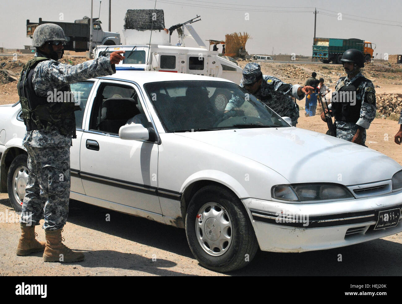 Federal police officers direct a car for a search during a vehicle ...