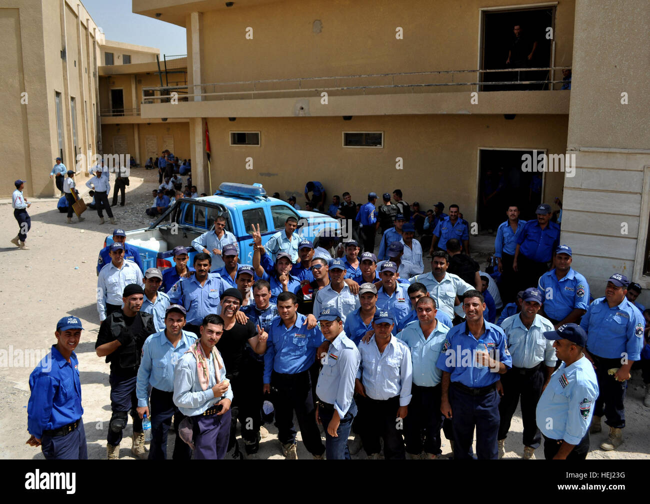 Members of the Iraqi Federal Police pose for a group photo moments ...