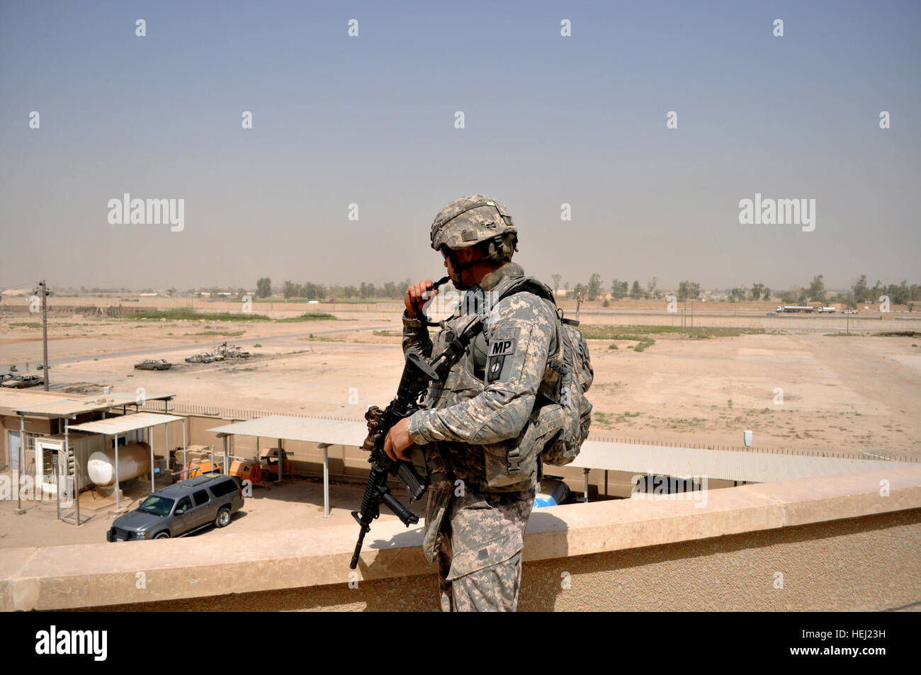 A Soldier in the 8th Military Police Brigade drinks water and provides ...