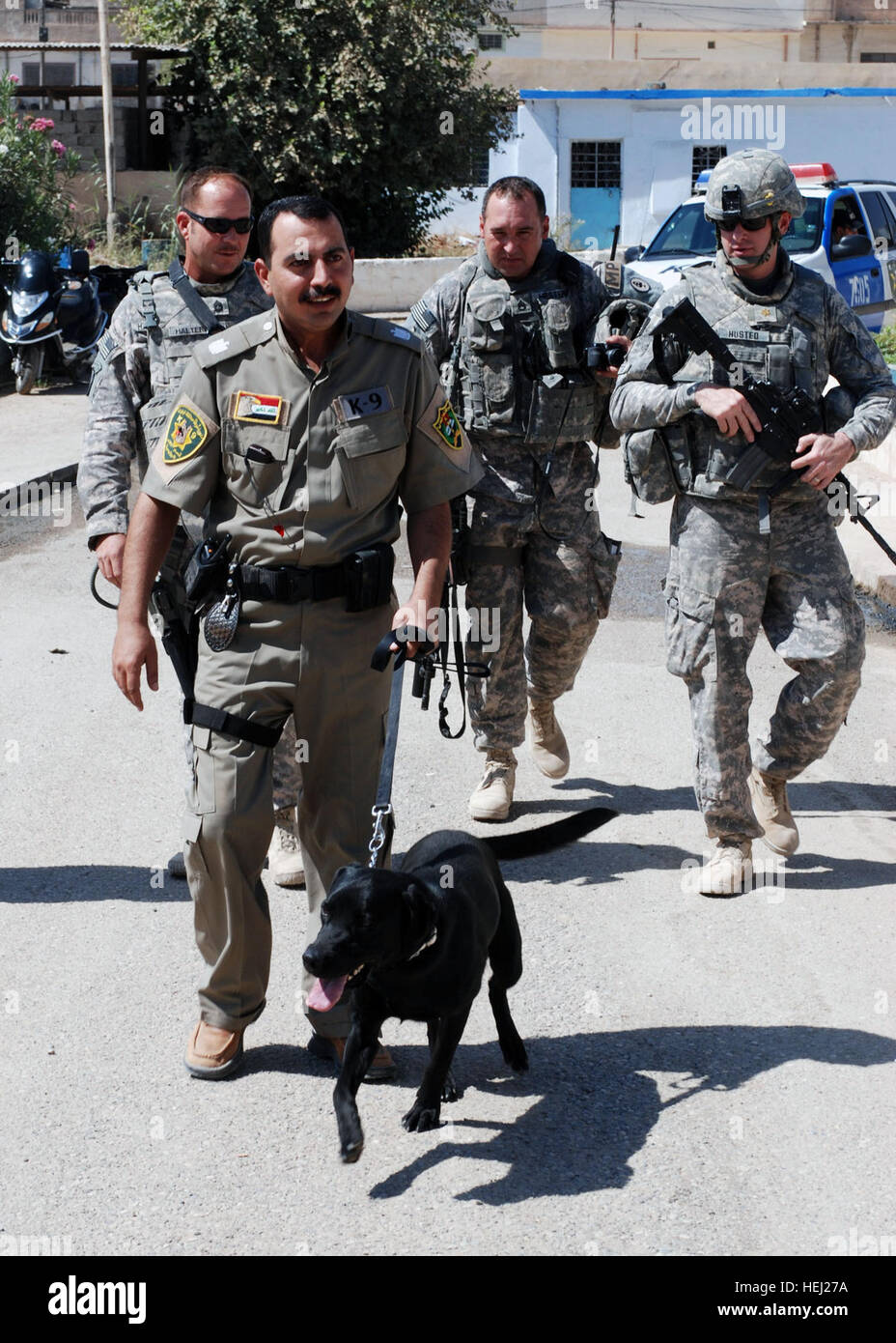 Maj. Shamel, kennel master for Mosul's Iraqi Police K-9 unit, walks ...