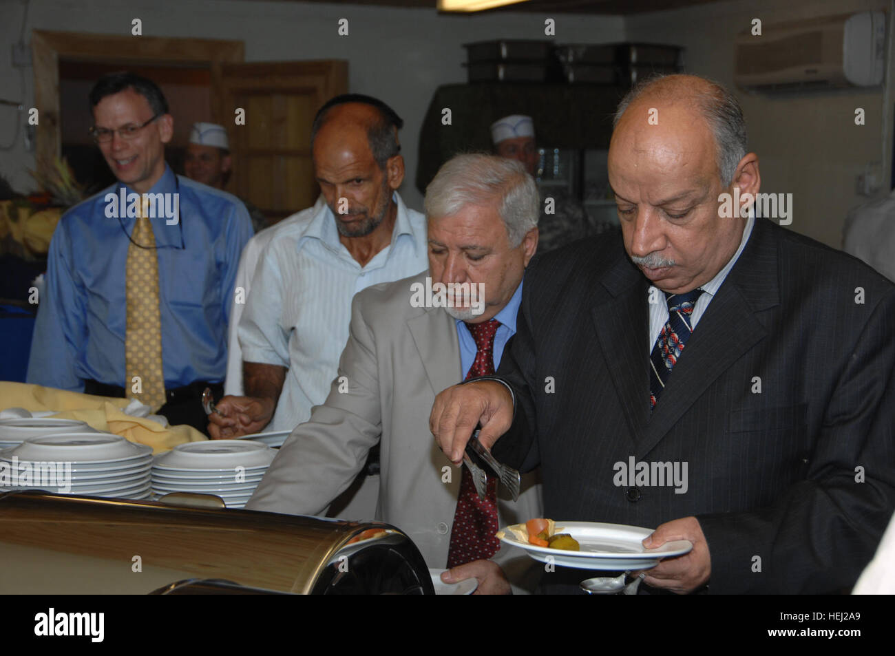Iraqi key leaders walk down the buffet line during a Ramadan dinner ...