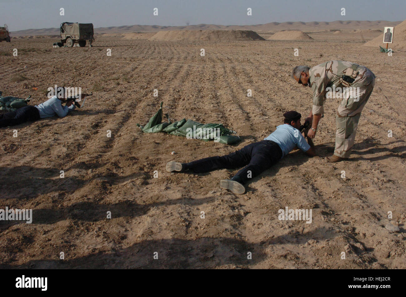 The Mamma Iraqi police chief takes a look at an officer's weapon at a ...