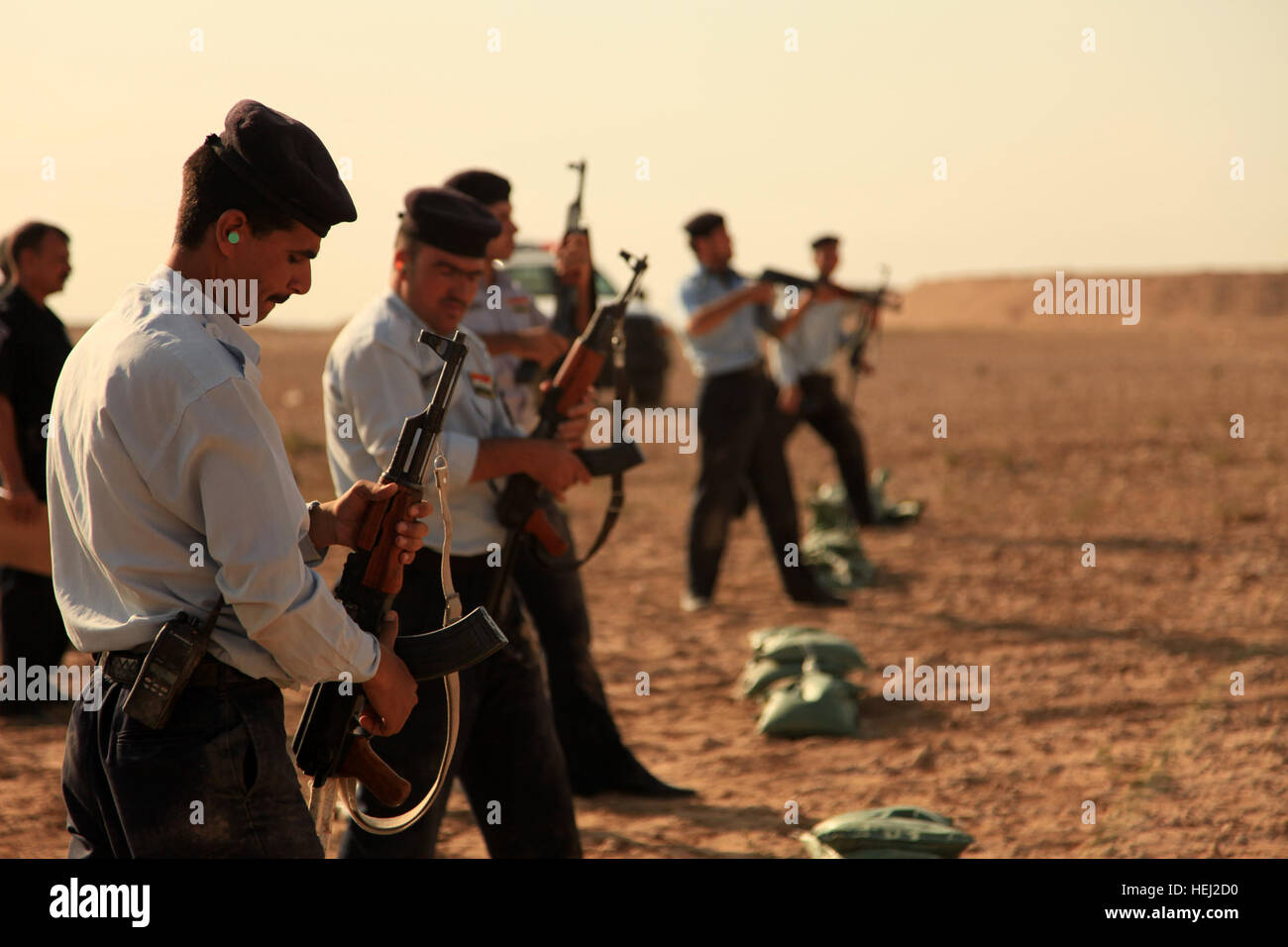 Iraqi police officers place their weapons on safe during AK-47 range ...
