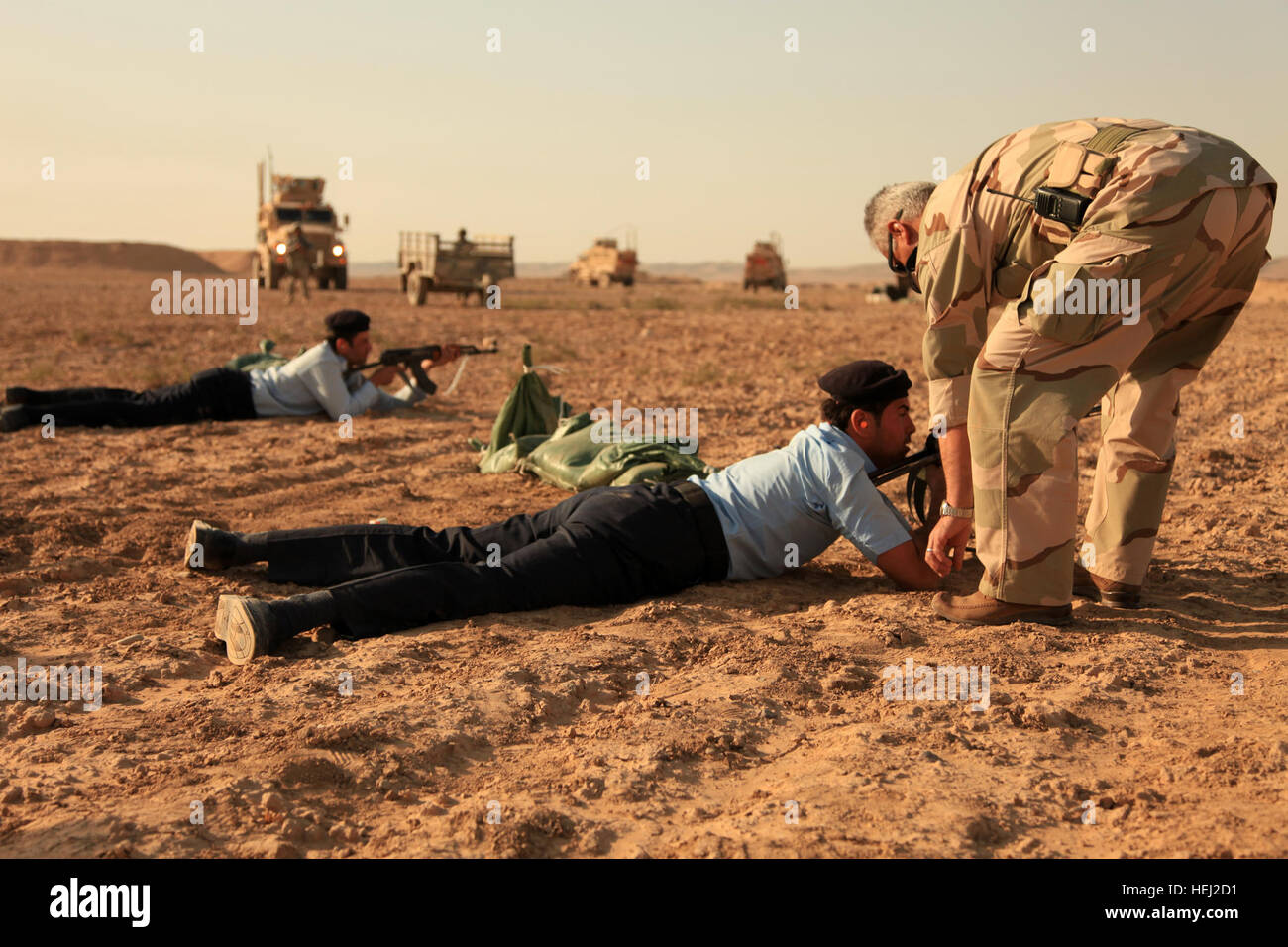 An Iraqi police officer receives instruction on how to properly fire ...