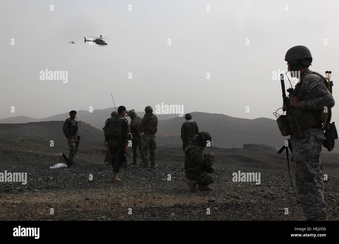 OH-58D Kiowa attack helicopters circle as coalition forces, alongside ...
