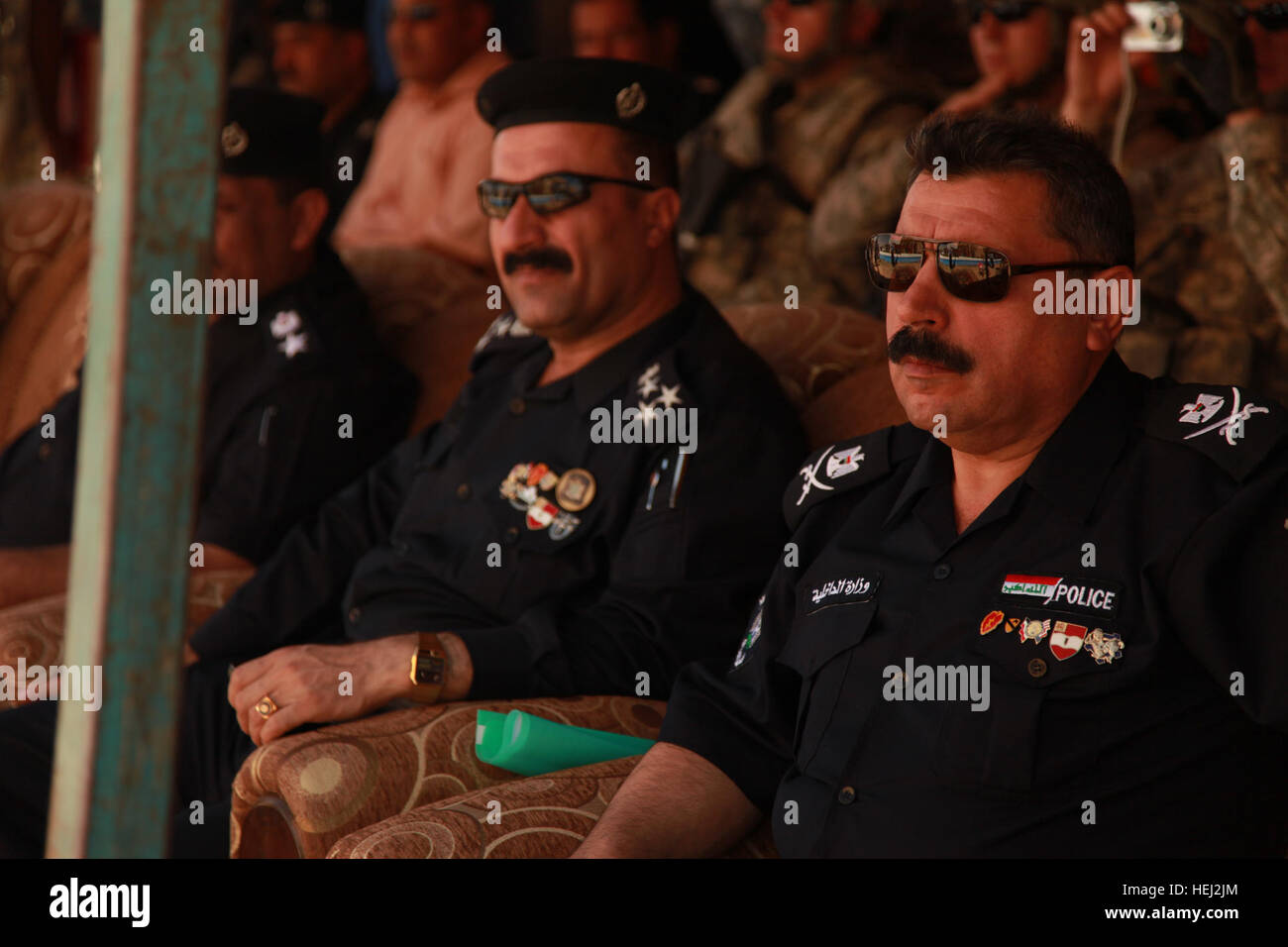 Iraqi police officers listen to speakers during an Iraqi police station ...
