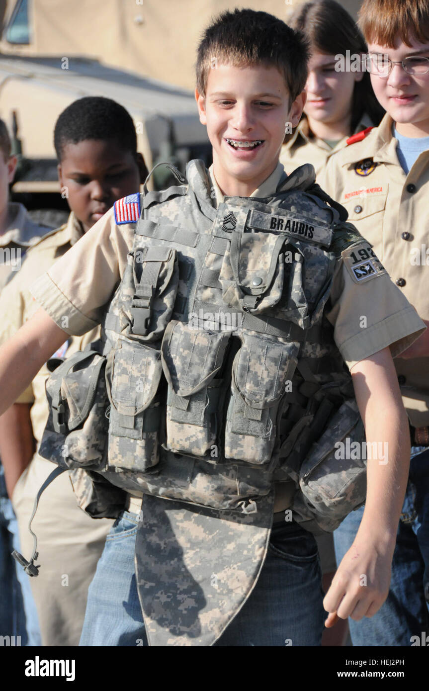 A boy scout with Troop 859 tries on Sgt. 1st Class Robert Braudis ...