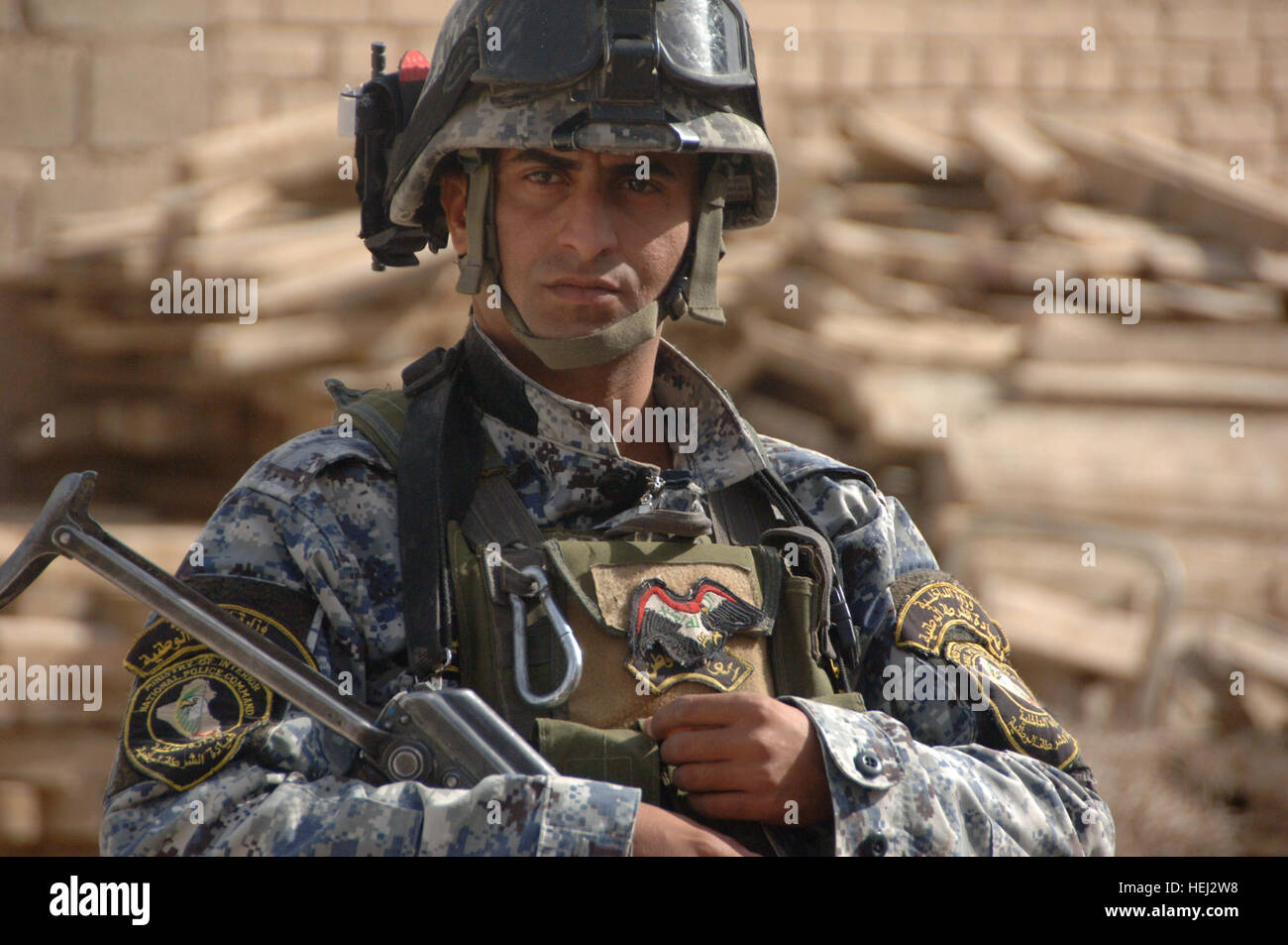 An Iraqi national policeman stands guard as U.S. Soldiers from Alpha ...