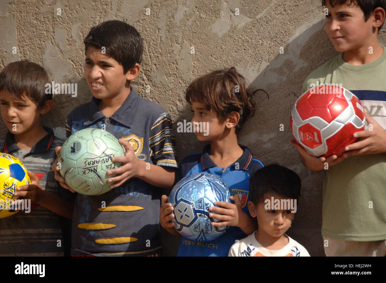 U.S. Soldiers and Iraqi national police distribute soccer balls to ...