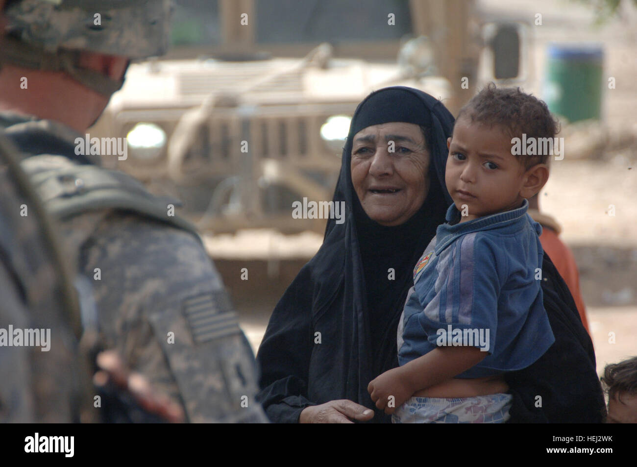 U.S. Soldiers and Iraqi national police distribute toys and soccer ...