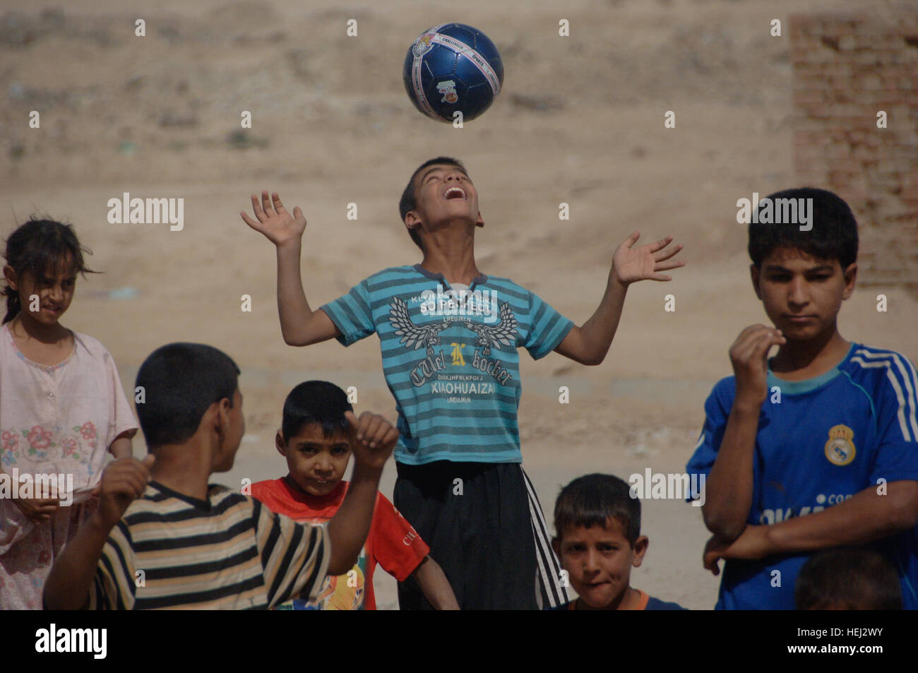 An Iraqi boy works on his soccer technique with a new soccer ball he ...