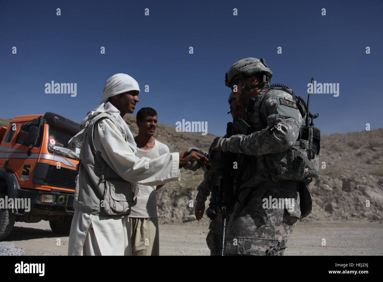 An Afghan contractor meets with U.S. Air Force 1st Lt. Graham Auten, a ...
