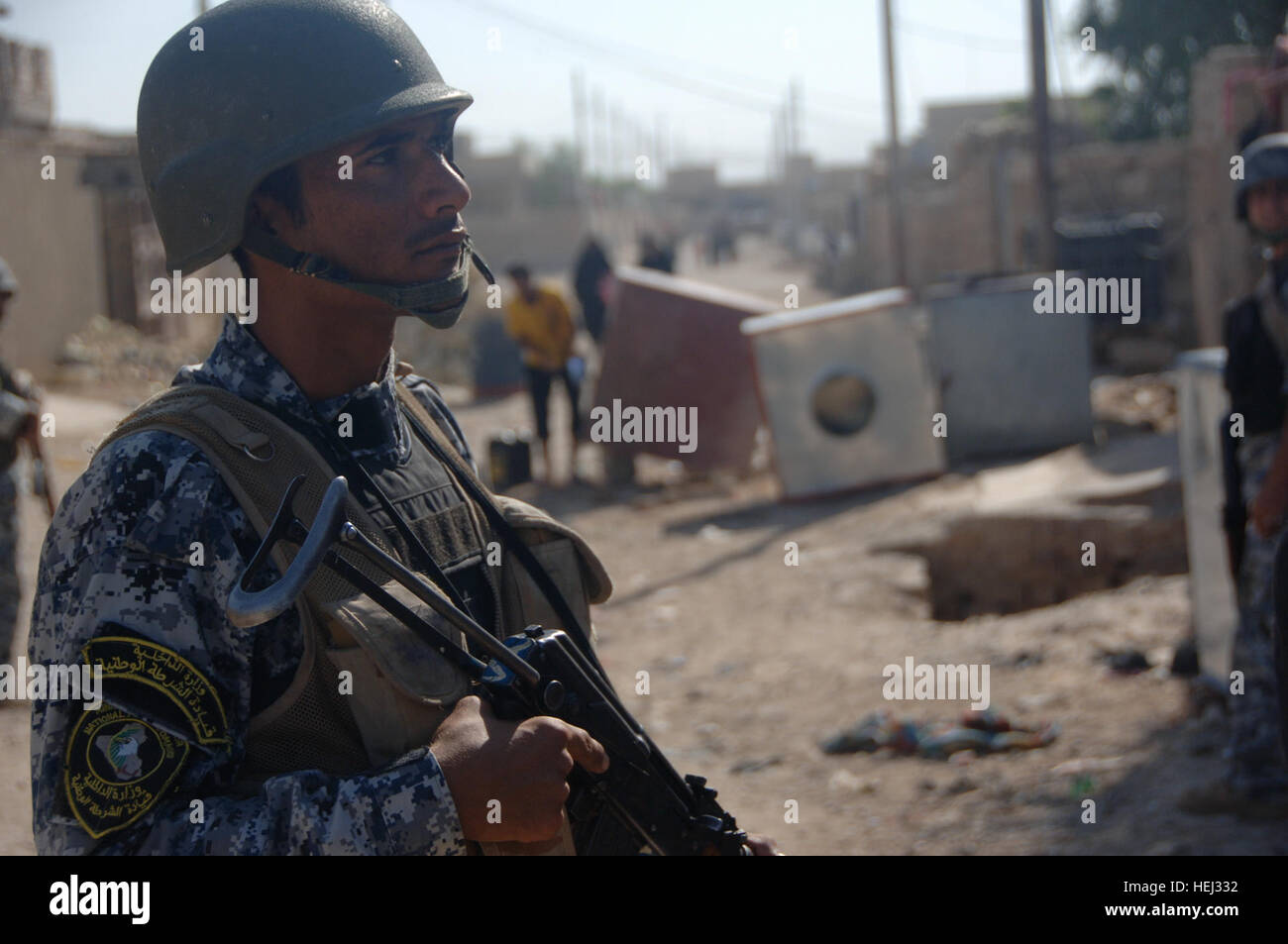 Iraqi police and U.S. Army soldiers conduct a combined foot patrol ...
