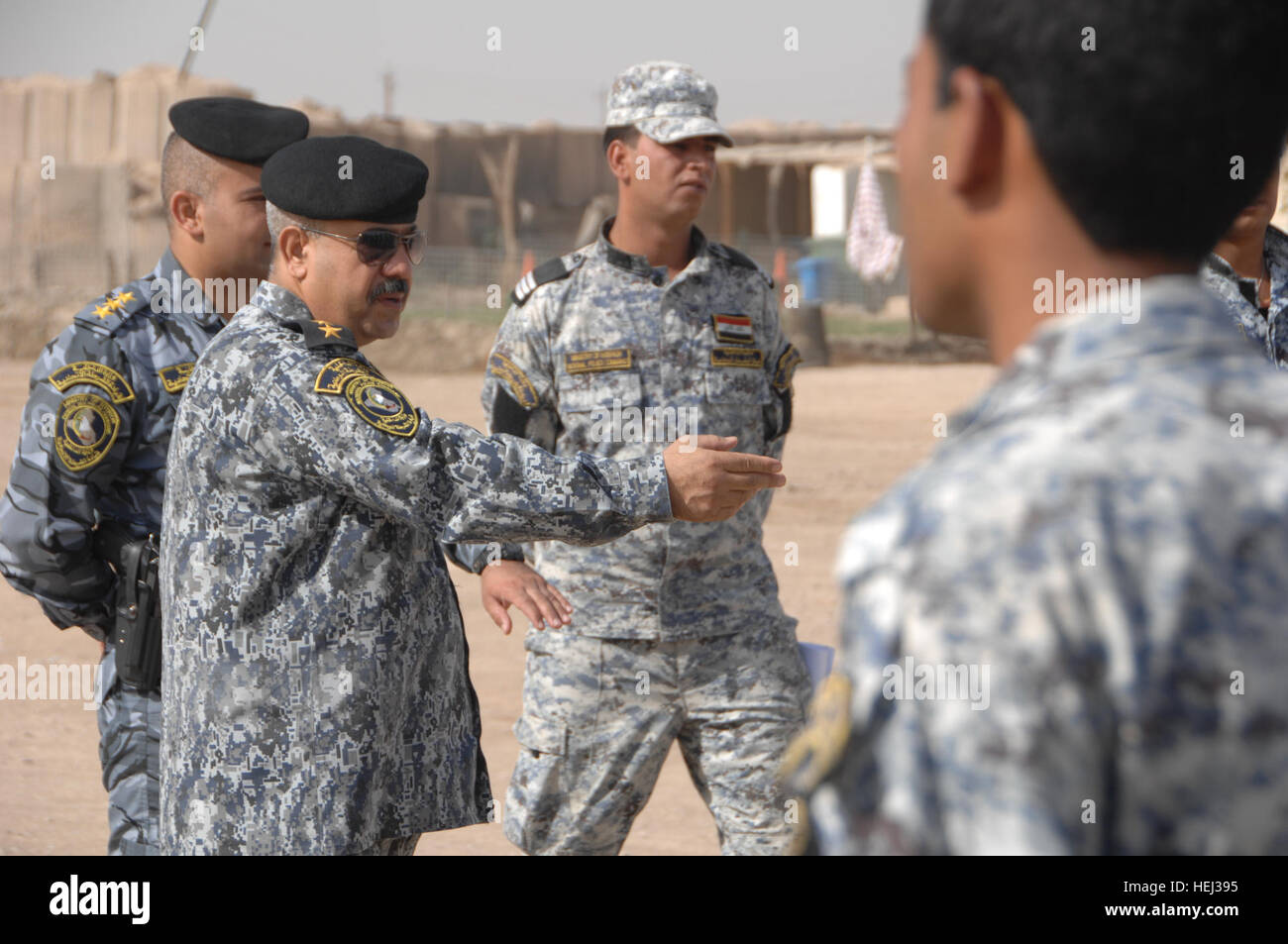 An Iraqi military police officer talks with his soldiers during ...