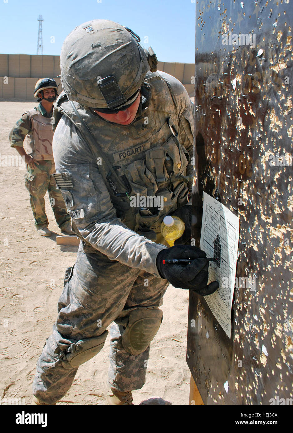 Sgt. Donovan Fogarty, of Anchorage, Alaska, marks down the distance ...