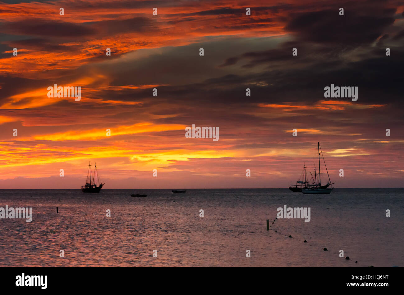 Picture showing the Golden hour with sail boats on sea anchored by the ...