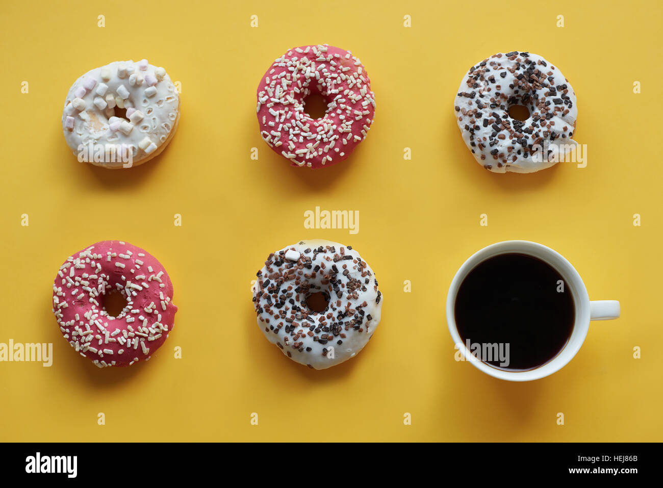Five donuts with cup of coffee Stock Photo - Alamy