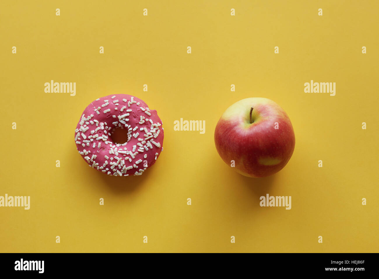 Apple and donut in the middle of picture Stock Photo - Alamy